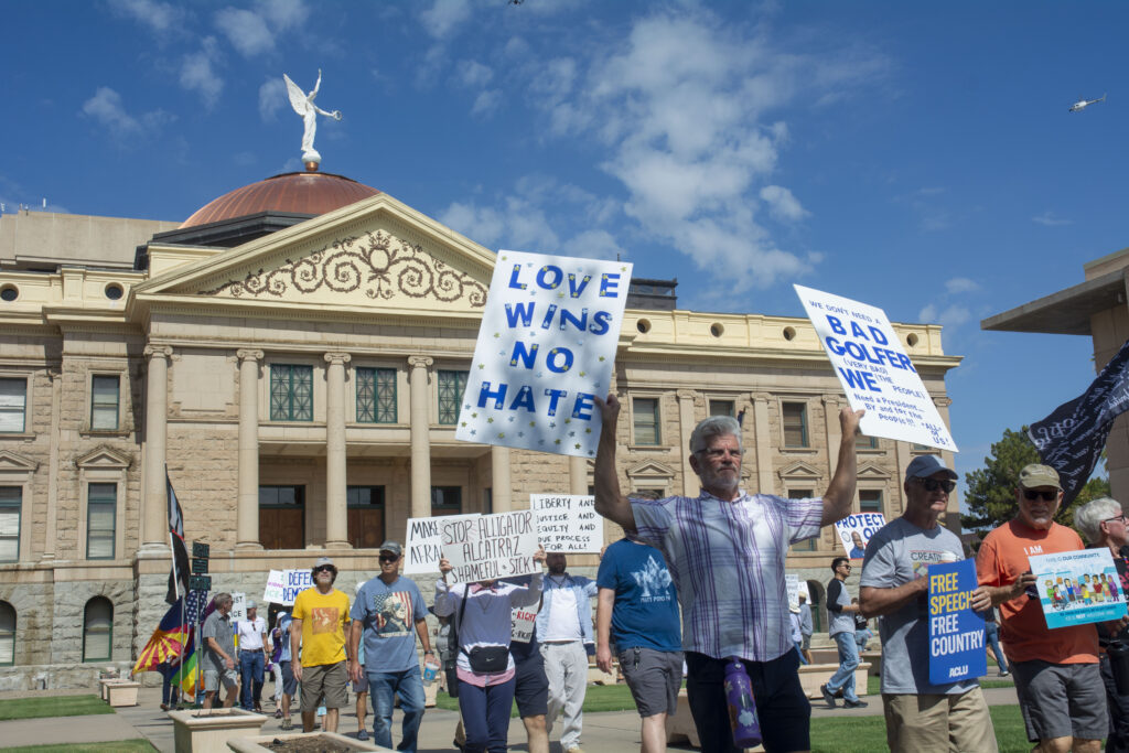 Protestors gather in Phoenix to protest Trump policies, honor late ...