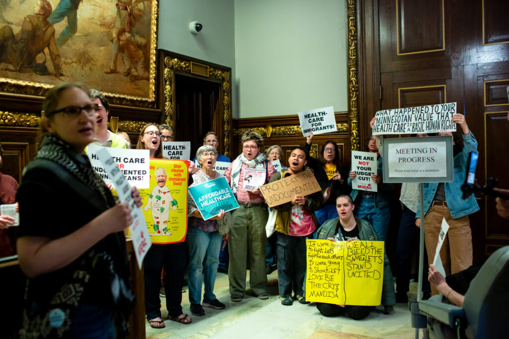 Immigrant rights activists protest plan to end low-cost health ...