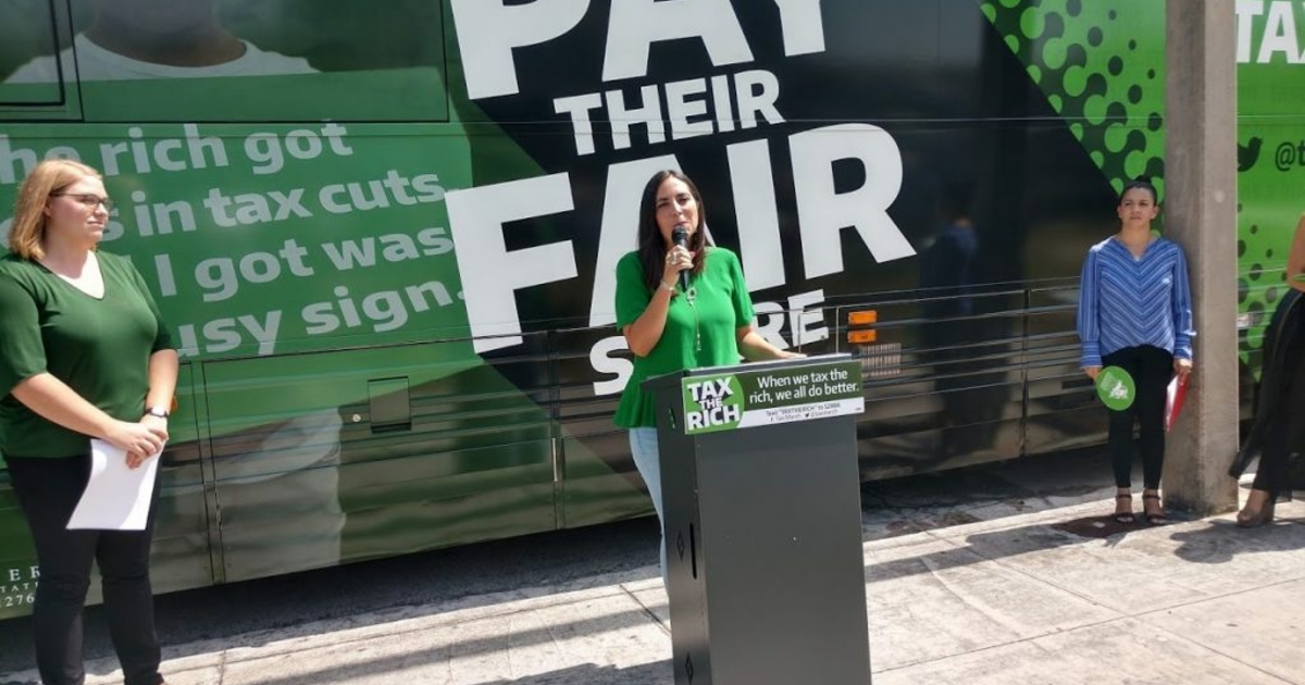 “Tax the Rich” bus parks across from Democratic debate spot | News From ...